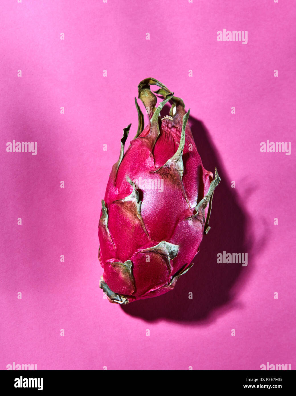 Juicy pink pitaya on a dark pink background with shadows Stock Photo ...