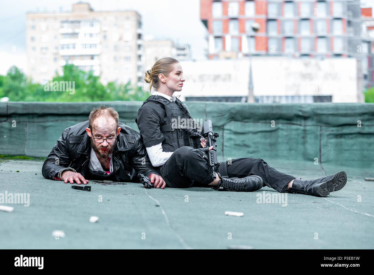 Actors rest from shooting a scene with weapons Stock Photo - Alamy