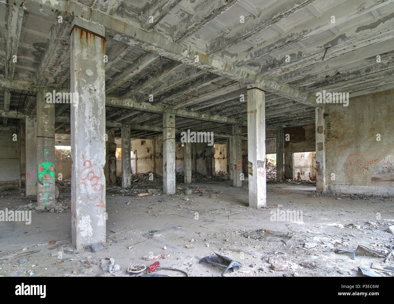 Ruins of abandoned and dilapidated factory overgrown of vegetation ...