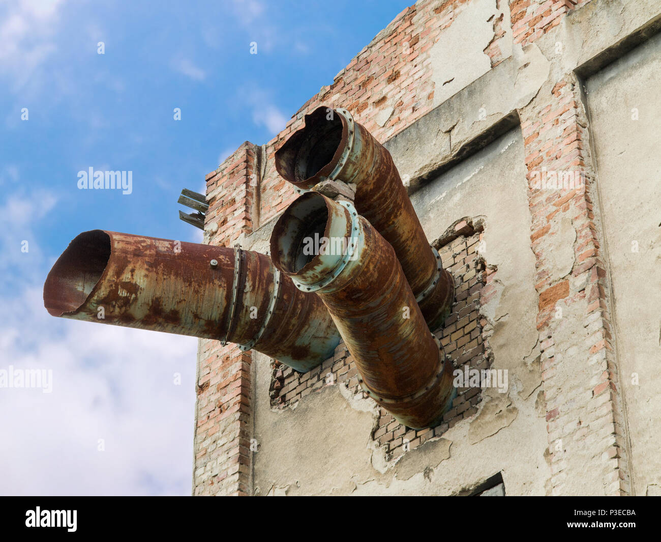 Ruins of abandoned and dilapidated factory overgrown of vegetation ...