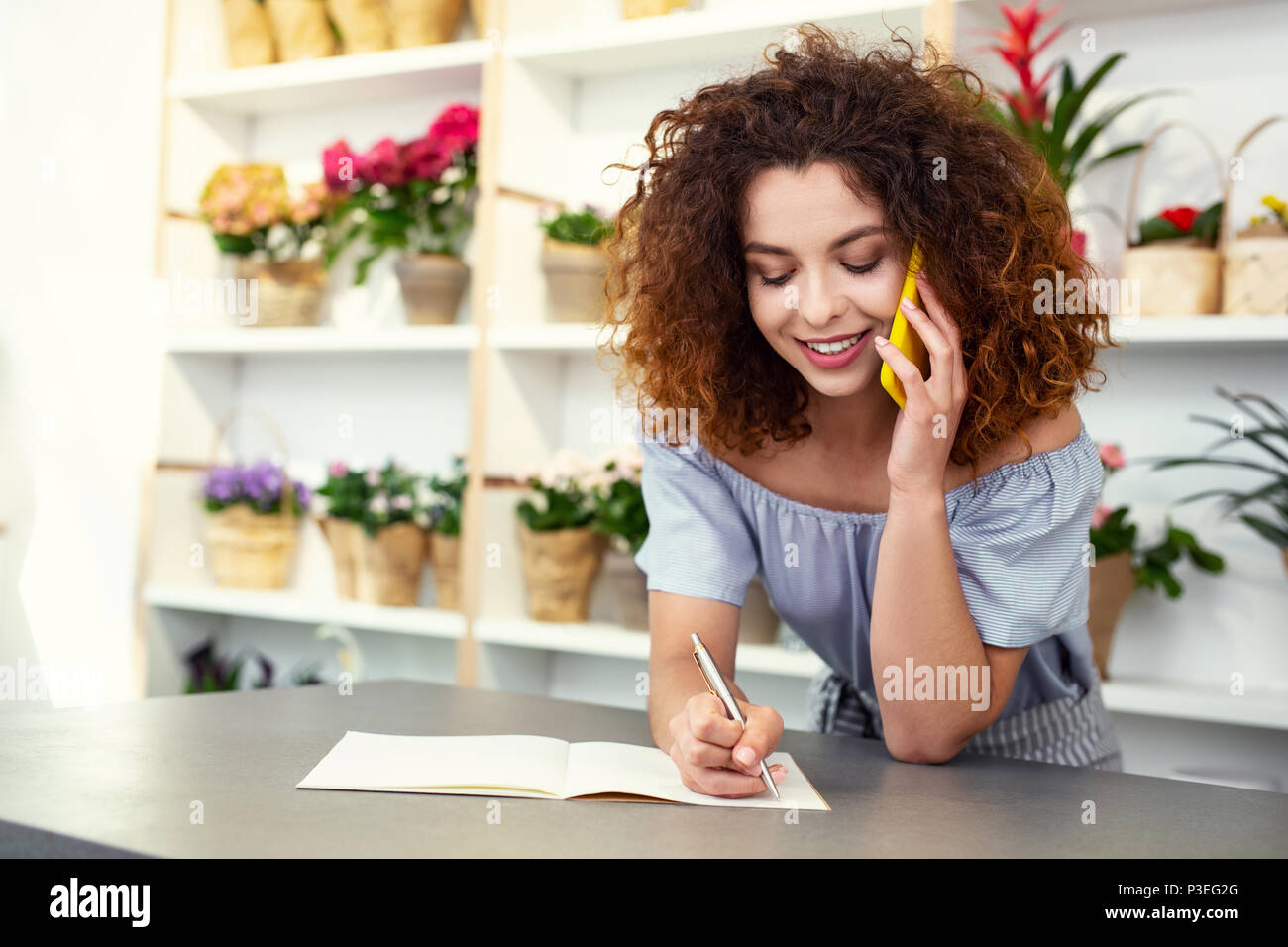 Positive joyful woman taking notes Stock Photo - Alamy