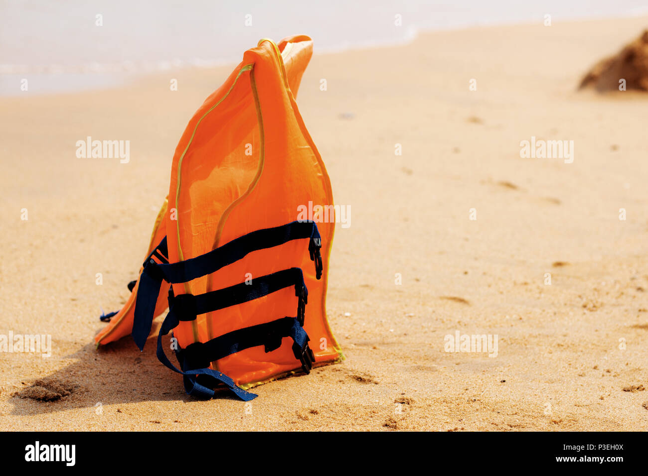 Life jacket on sand beach with sunlight Stock Photo - Alamy