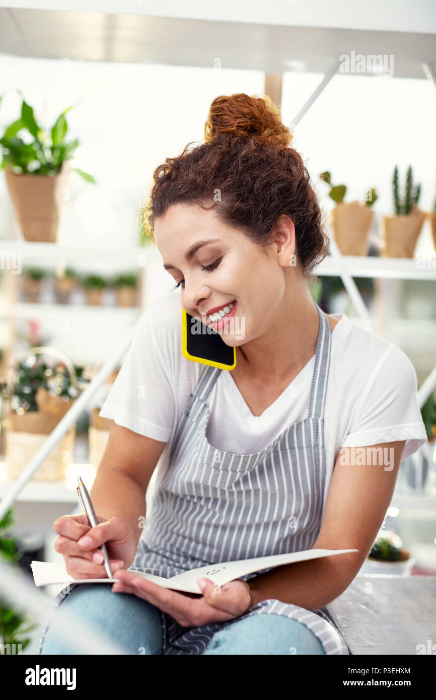 Delighted happy woman taking notes Stock Photo - Alamy