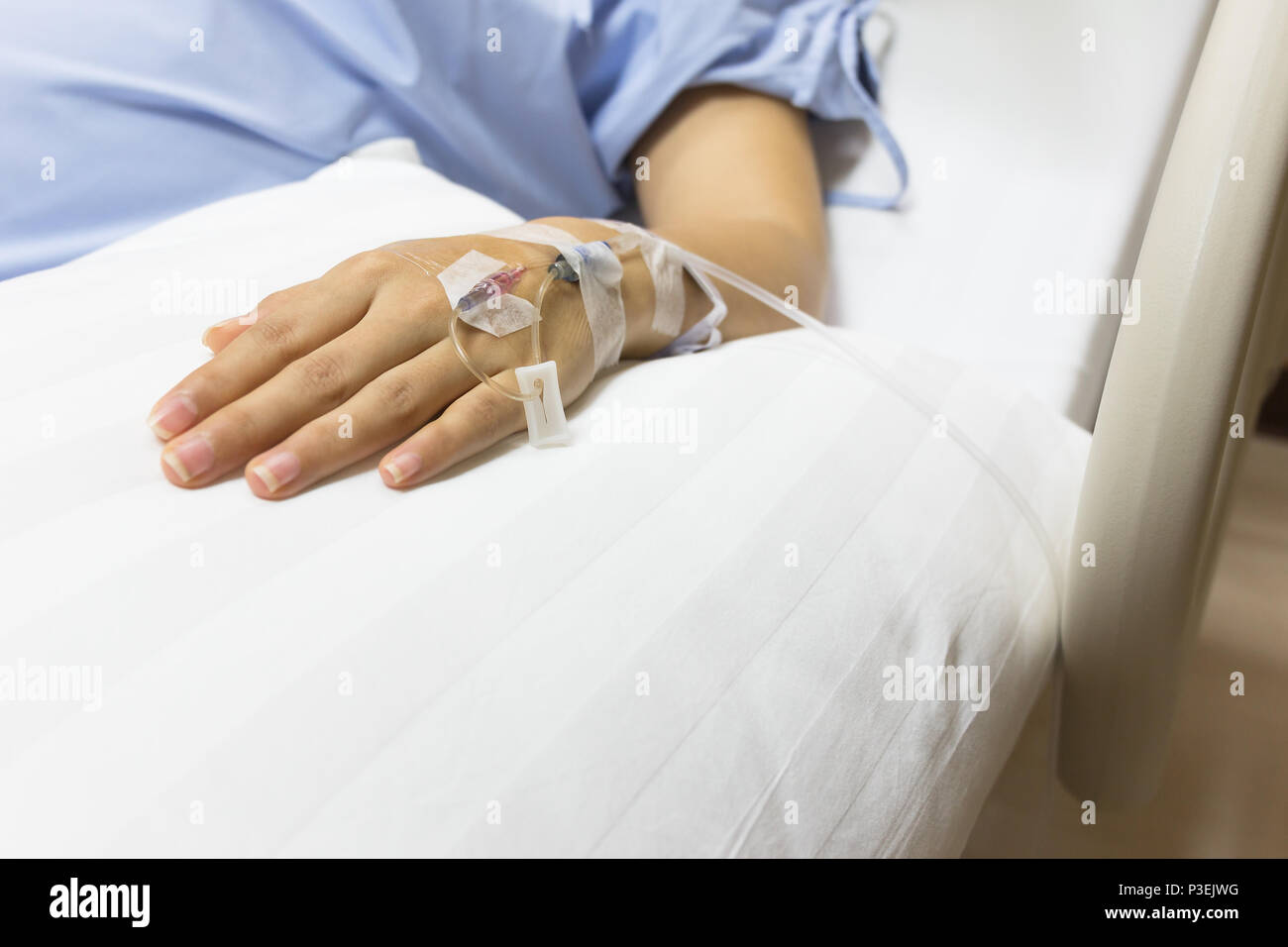 Asian Pregnant Woman patient is on drip receiving a saline solution on ...