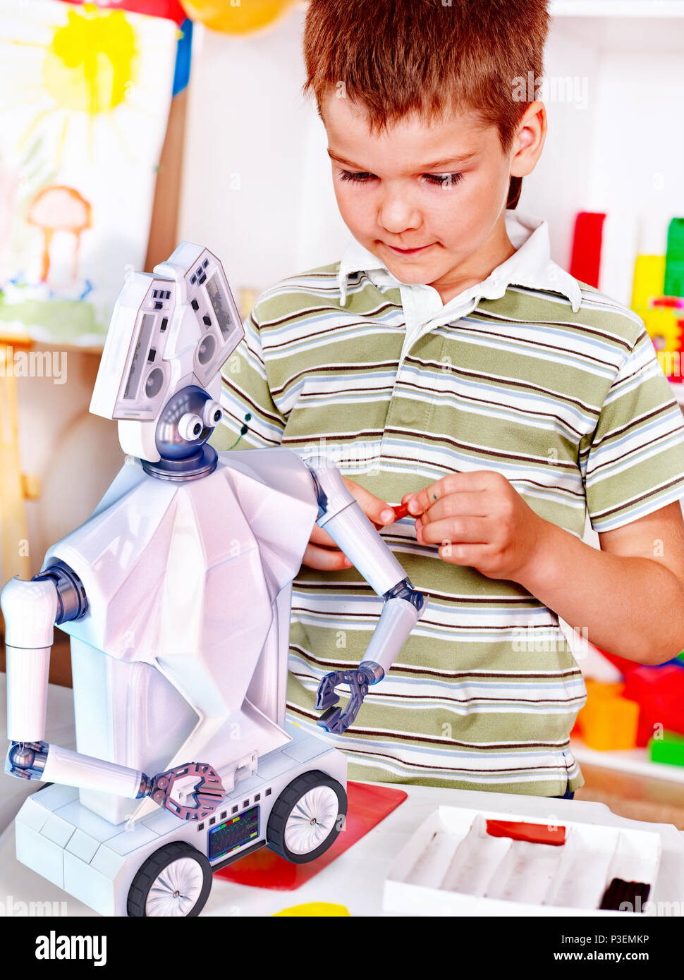 Child build robot toy. Kid engaged robotics in programming classes ...