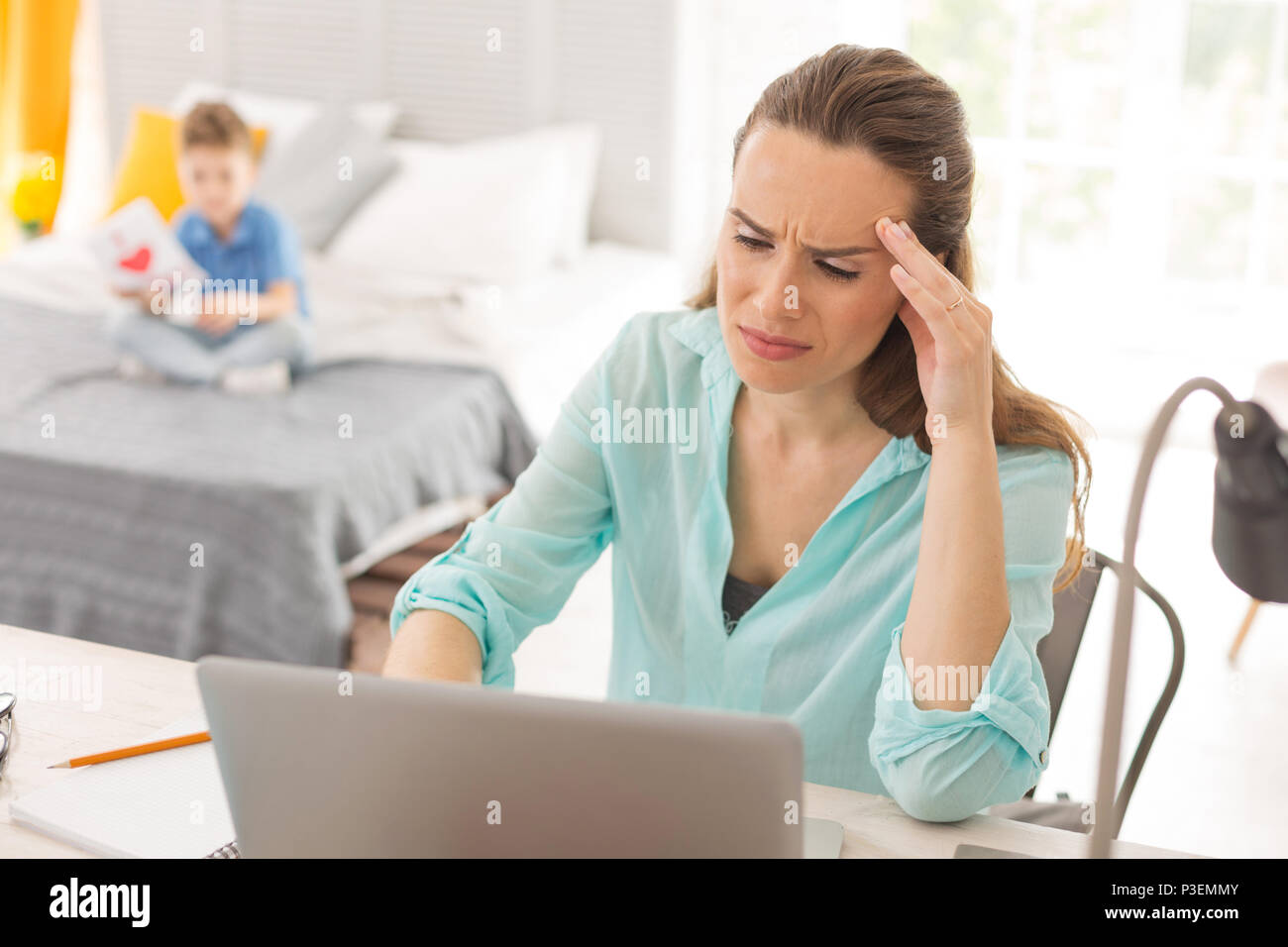 Freelancer having strong headache after long workday Stock Photo - Alamy