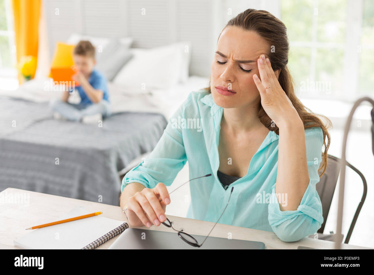Busy working family woman having strong headache Stock Photo - Alamy