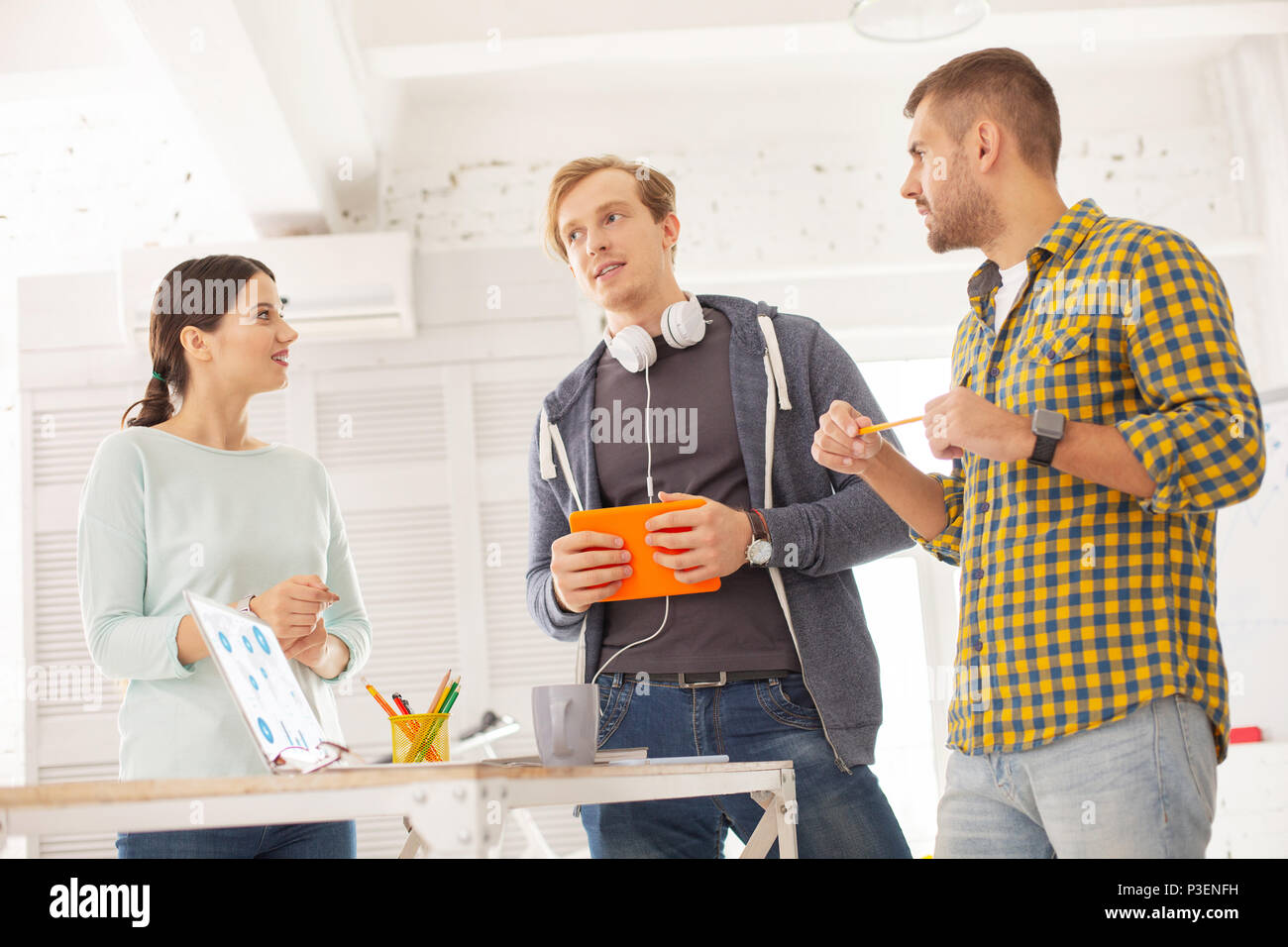 Inspired three colleagues changing strategy Stock Photo - Alamy