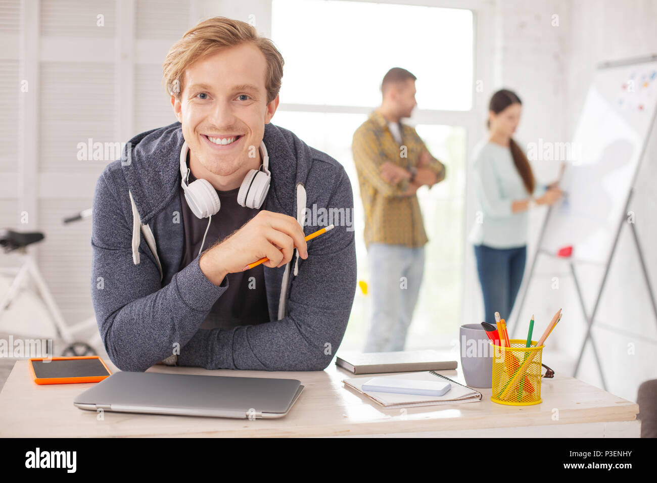 Cheerful male employee smiling to camera Stock Photo - Alamy