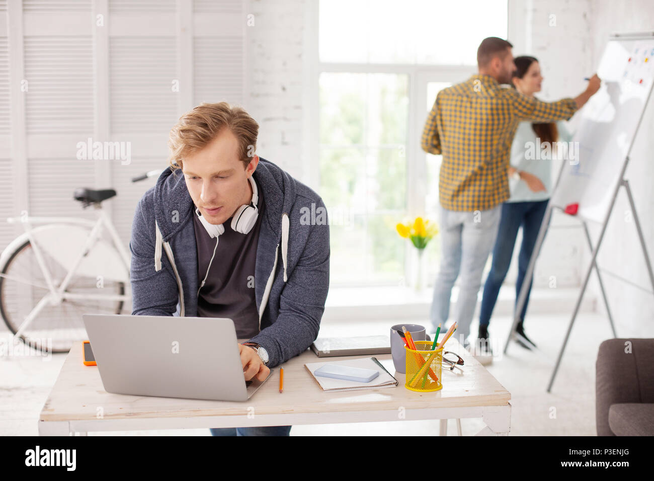 Focused male employee sending email Stock Photo - Alamy