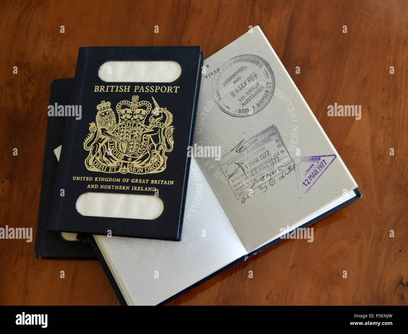 blue british passports with one open with entry and exit stamps shown ...