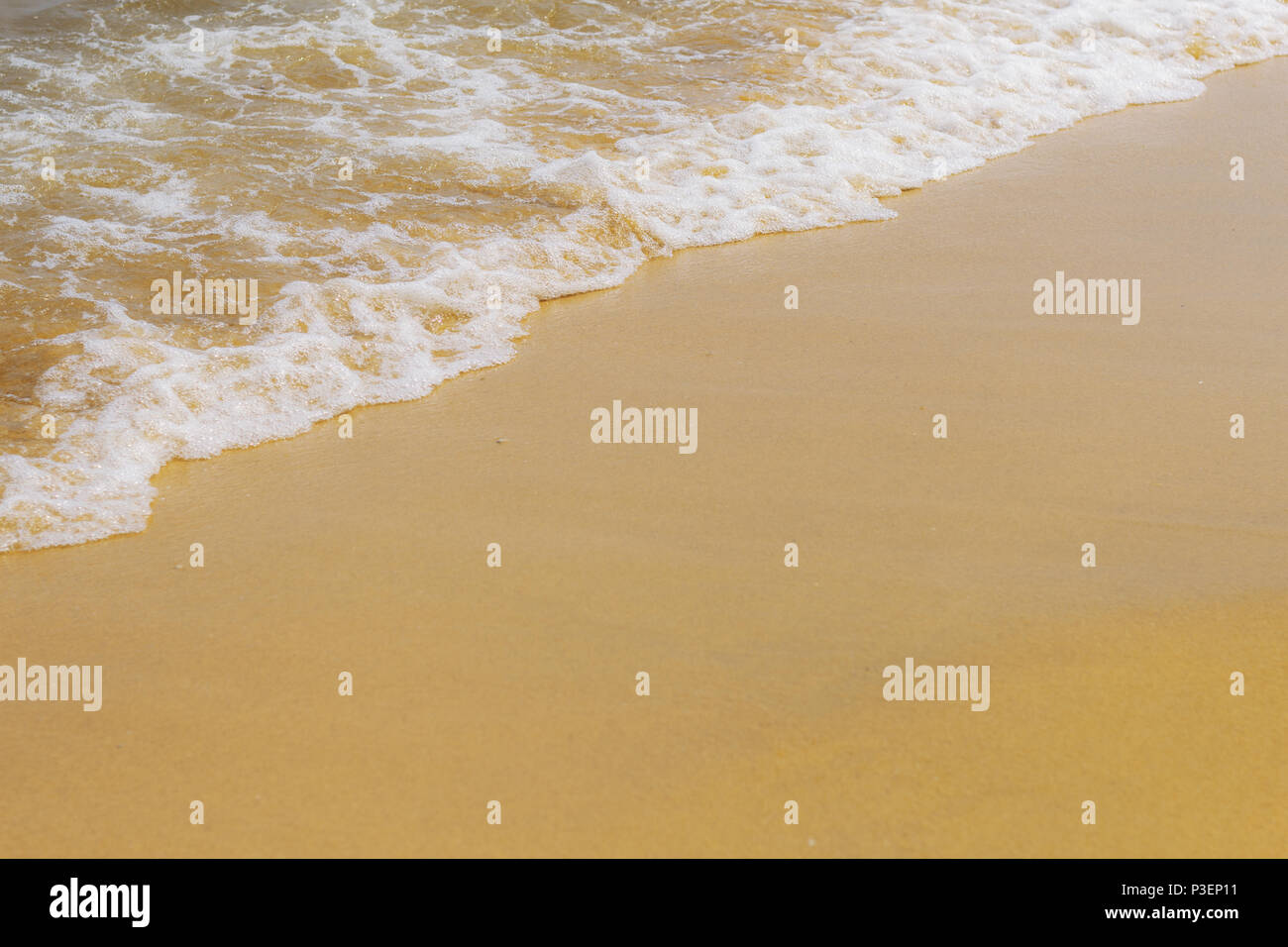 Water waves on sand with the sunlight Stock Photo - Alamy