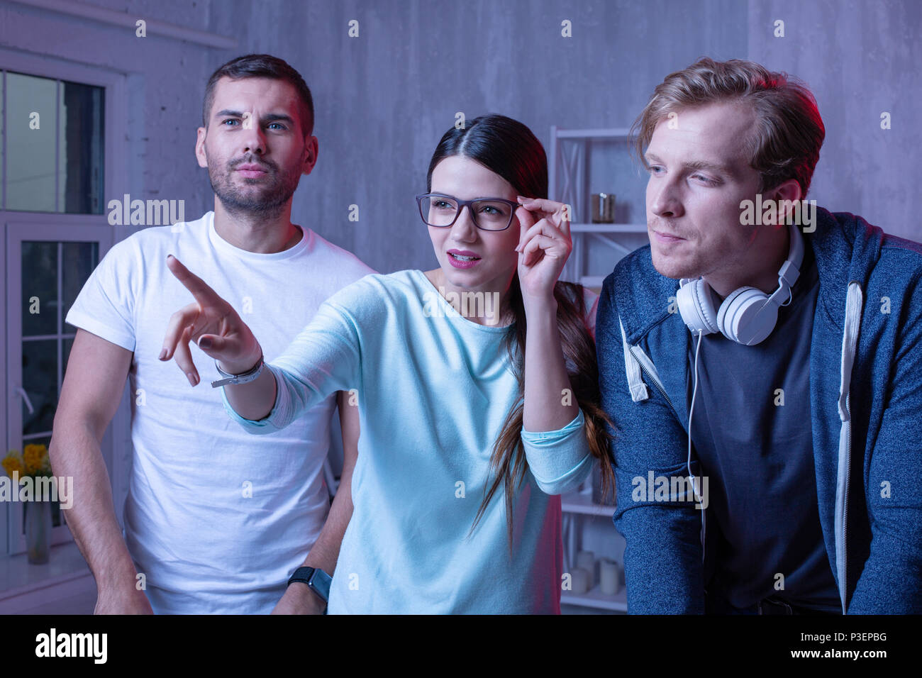 Focused three colleagues determining problem Stock Photo - Alamy