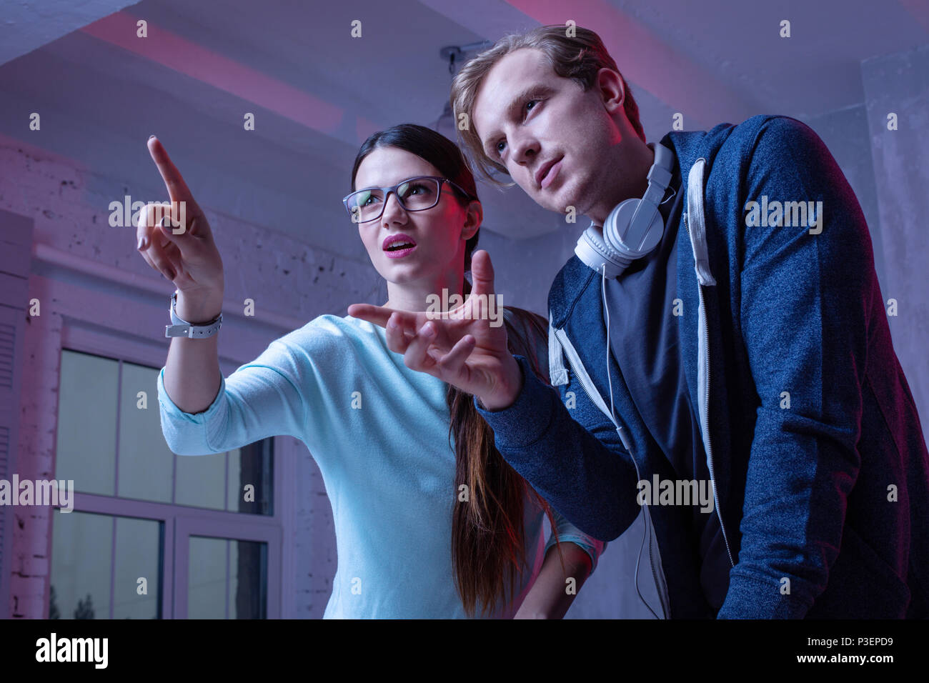 Concerned two colleagues measuring problem Stock Photo - Alamy