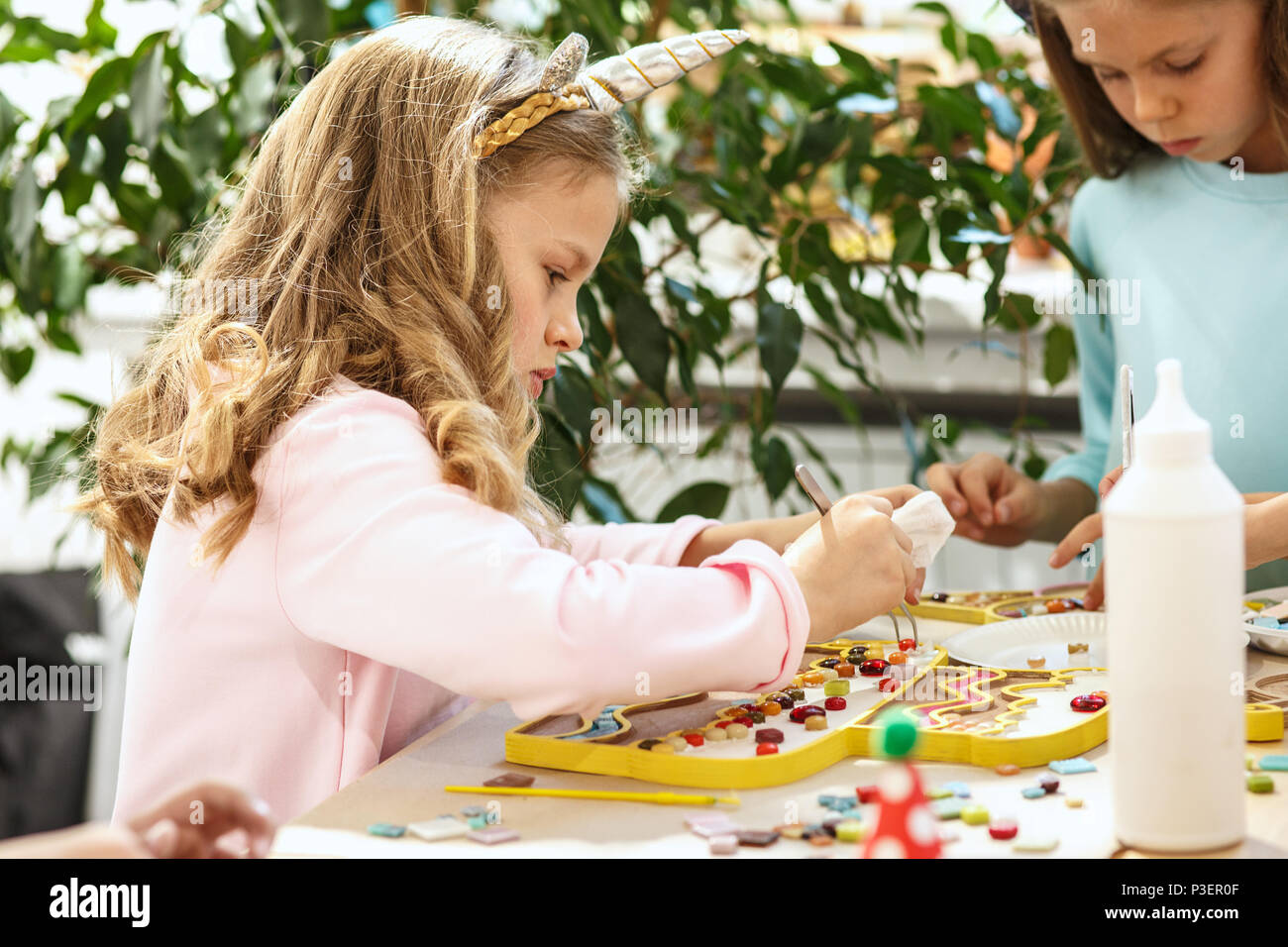 mosaic puzzle art for kids, children's creative game. two sisters are ...