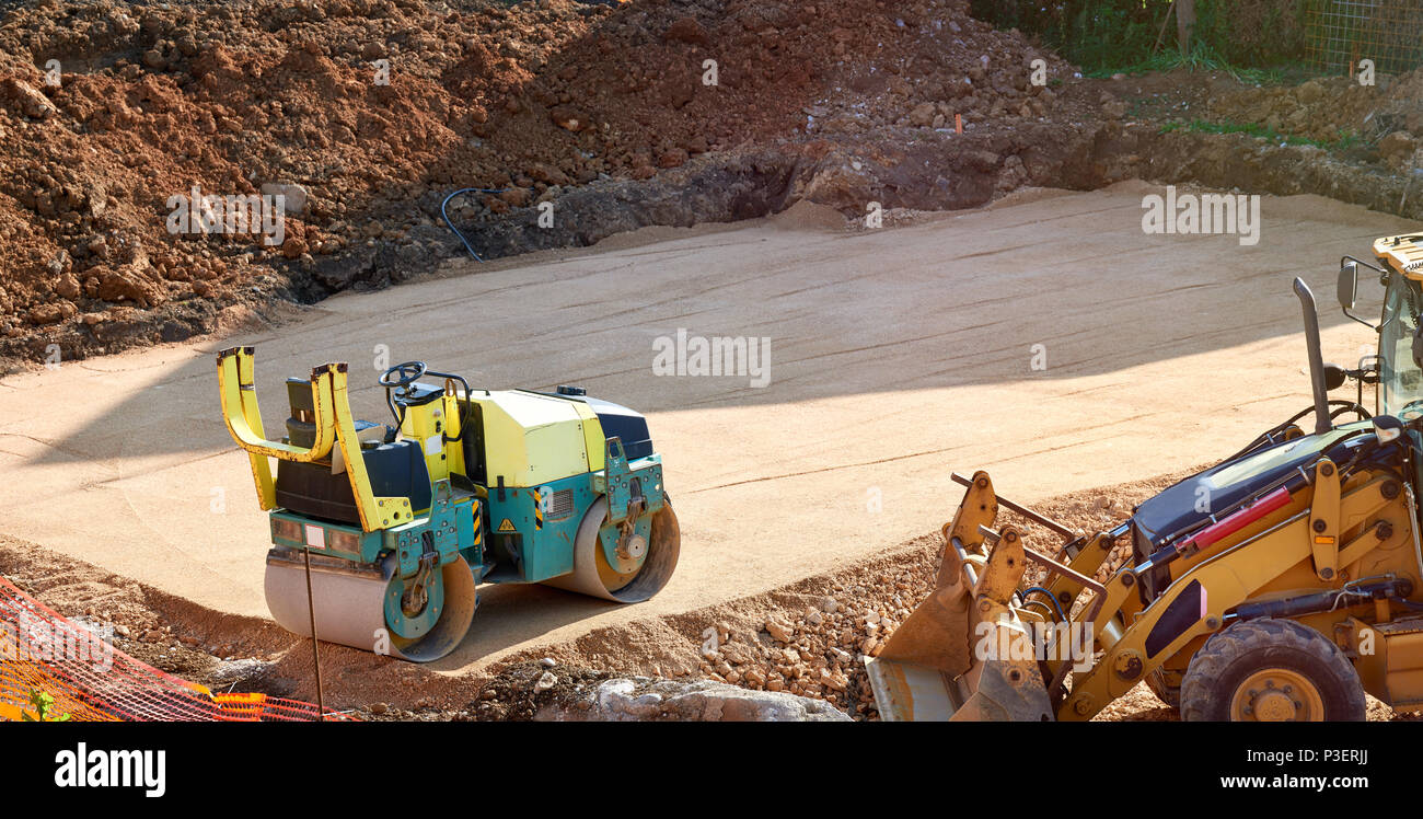 Construction steamroller and bulldozer on a house construction ...