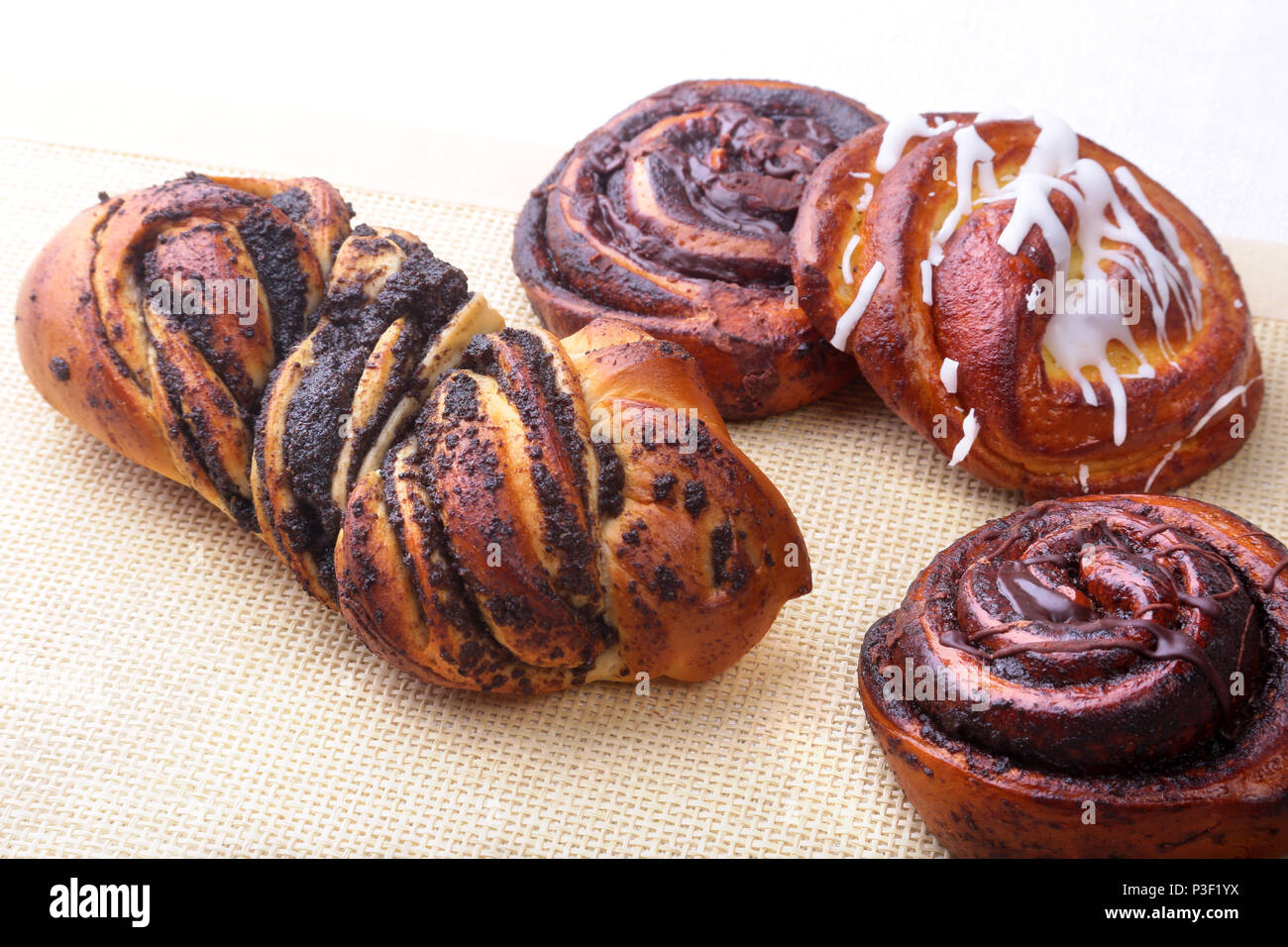 Freshly baked homemade sweet rolls with cinnamon on white background ...