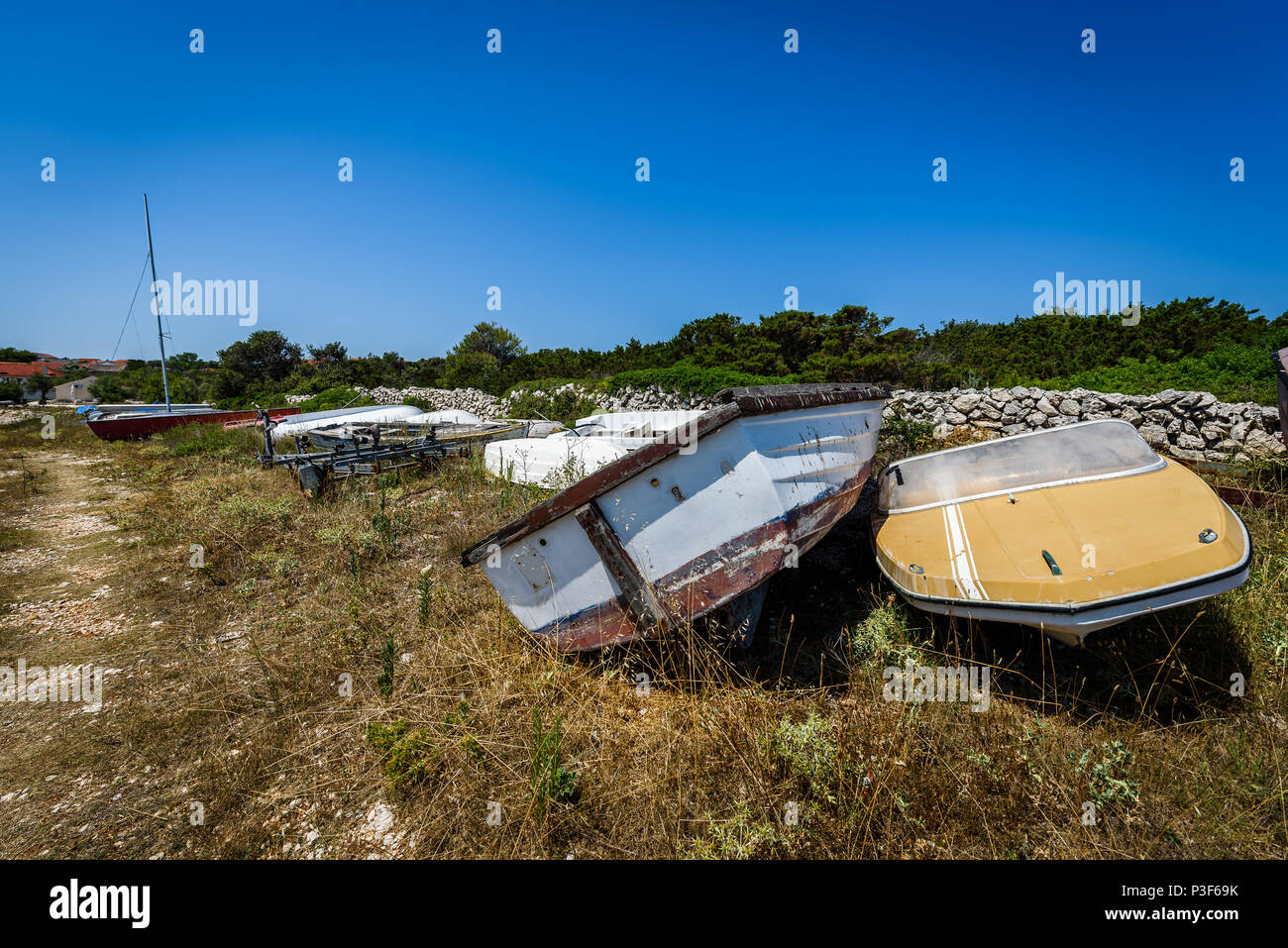 Old abandoned wrecked speed boat at ship or boat graveyard. Lots of ...