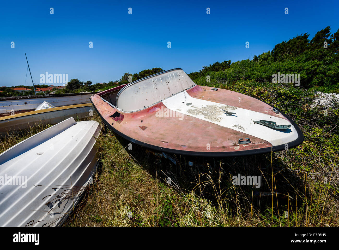 Old abandoned wrecked speed boat at ship or boat graveyard. Lots of ...