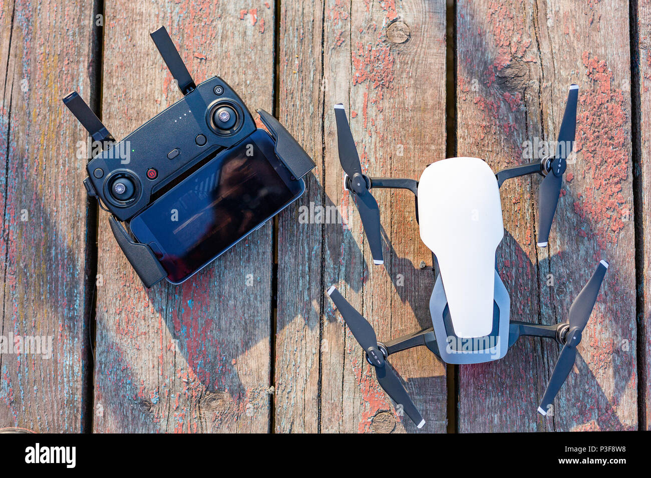 Drone and control panel on an old board. Top view Stock Photo - Alamy