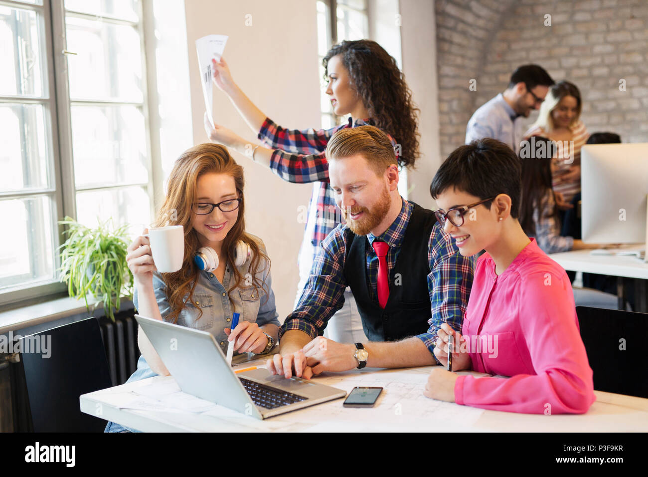 Group of young architects working on computer Stock Photo - Alamy