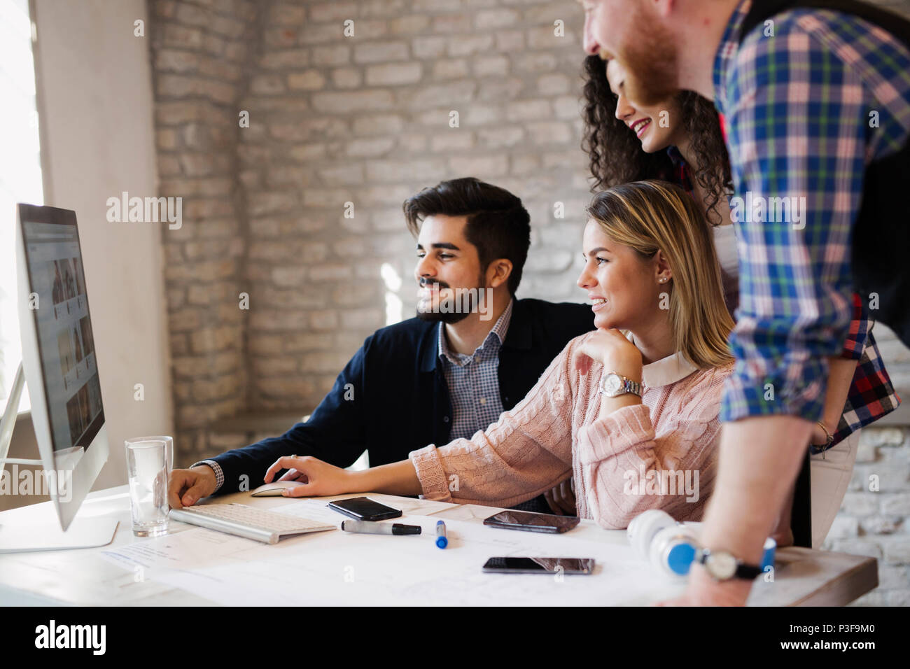 Group of young architects working on computer Stock Photo - Alamy