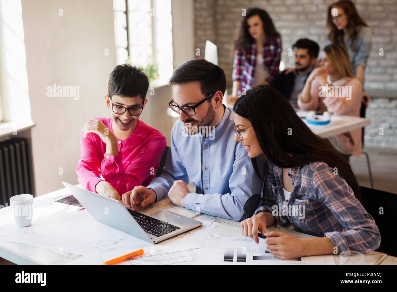 Group of young architects working on computer Stock Photo - Alamy