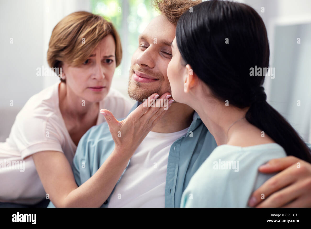 Sad aged woman touching her sons cheek Stock Photo - Alamy