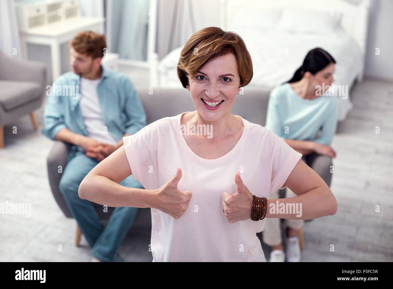 Happy nice woman showing Ok signs Stock Photo - Alamy