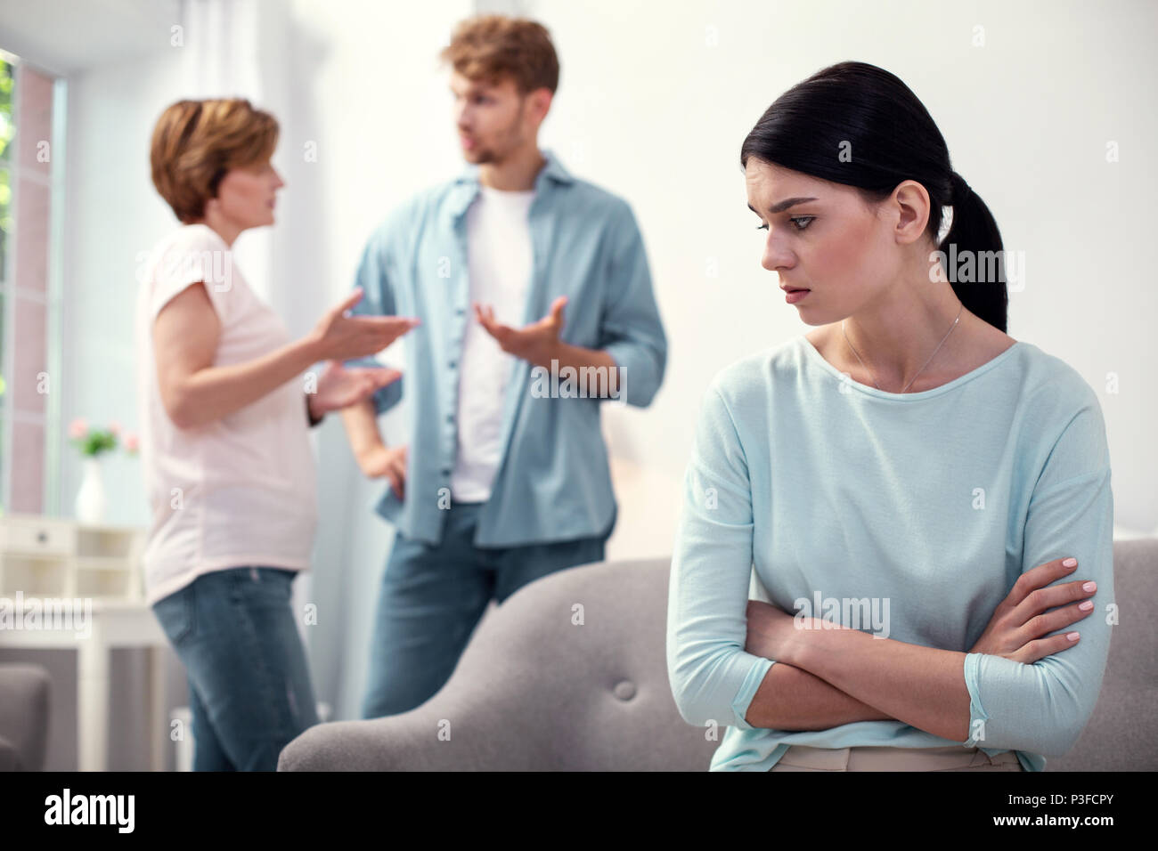 Nice young woman standing cross handed Stock Photo - Alamy