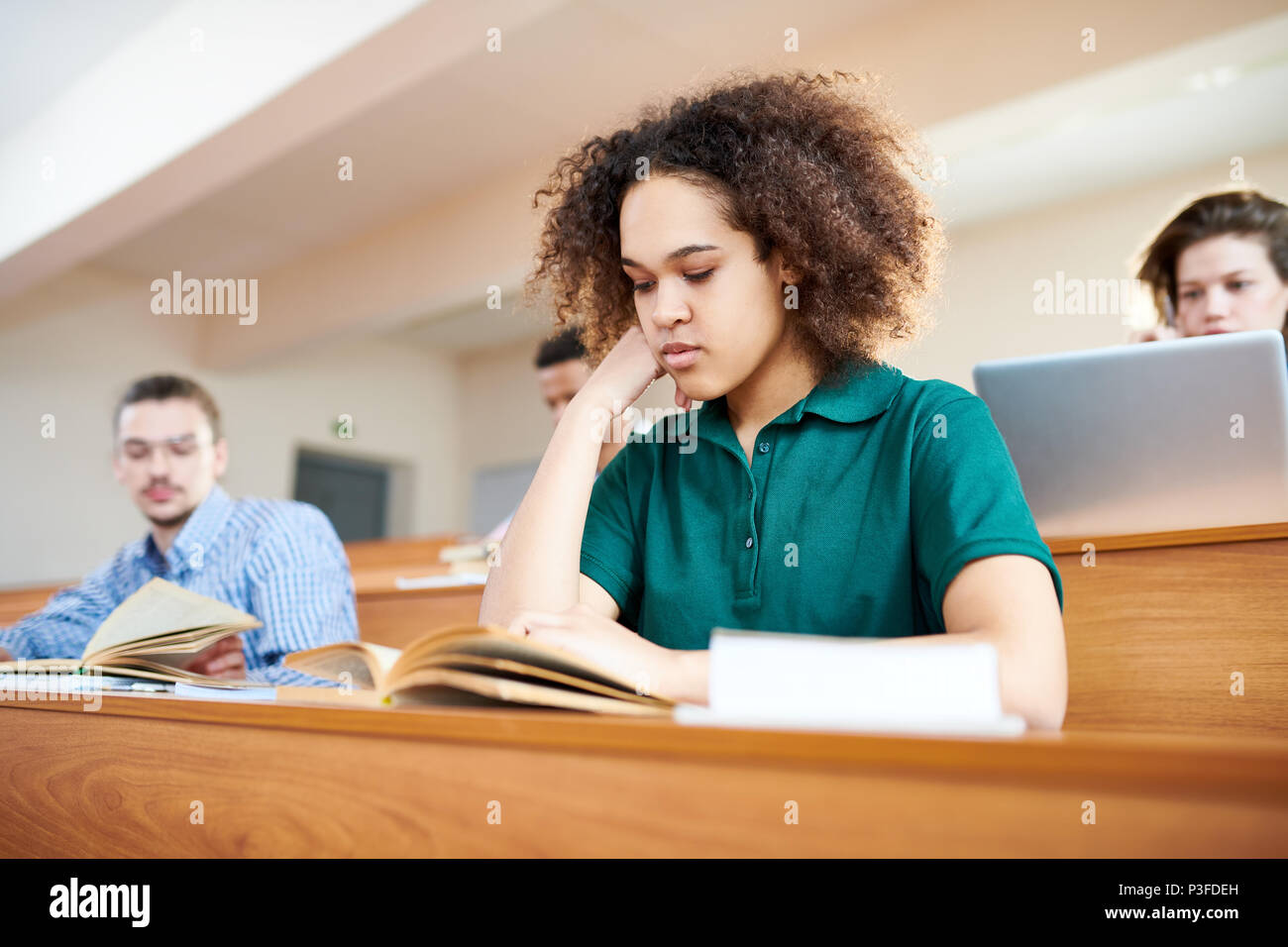 Concentrated African-American student reading textbook Stock Photo - Alamy Concentrated African-American student reading textbook Stock Photo - Alamy