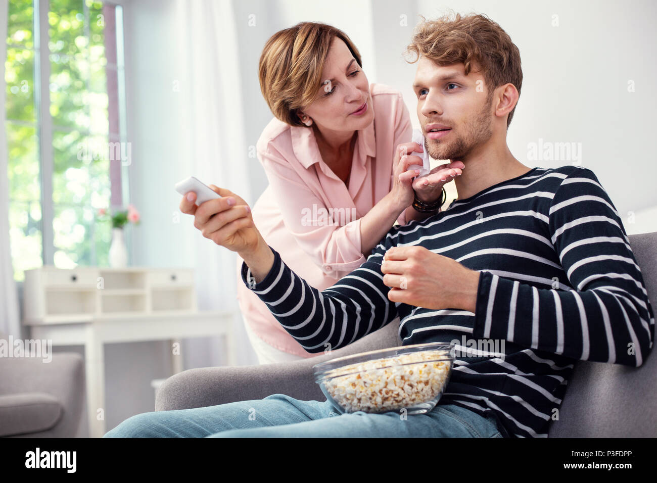 Nice young man watching TV Stock Photo - Alamy