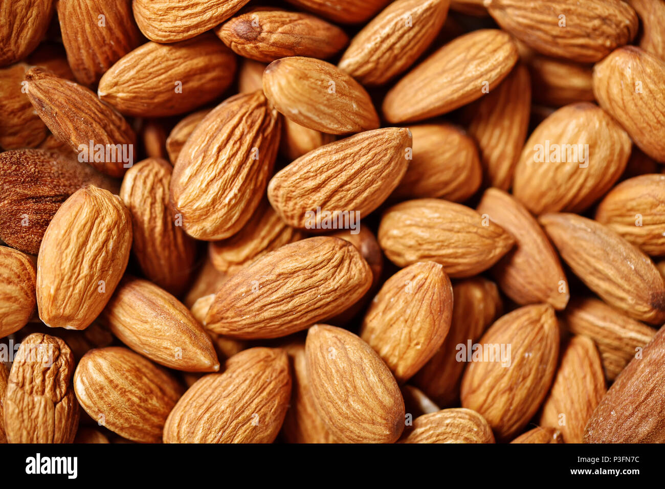 Almond on a wooden table in the summer garden. Useful food. Healthy ...