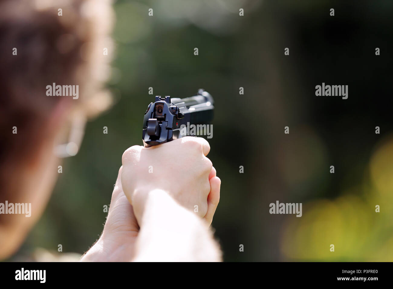 Young boy practice shooting guns on outdoor Stock Photo - Alamy