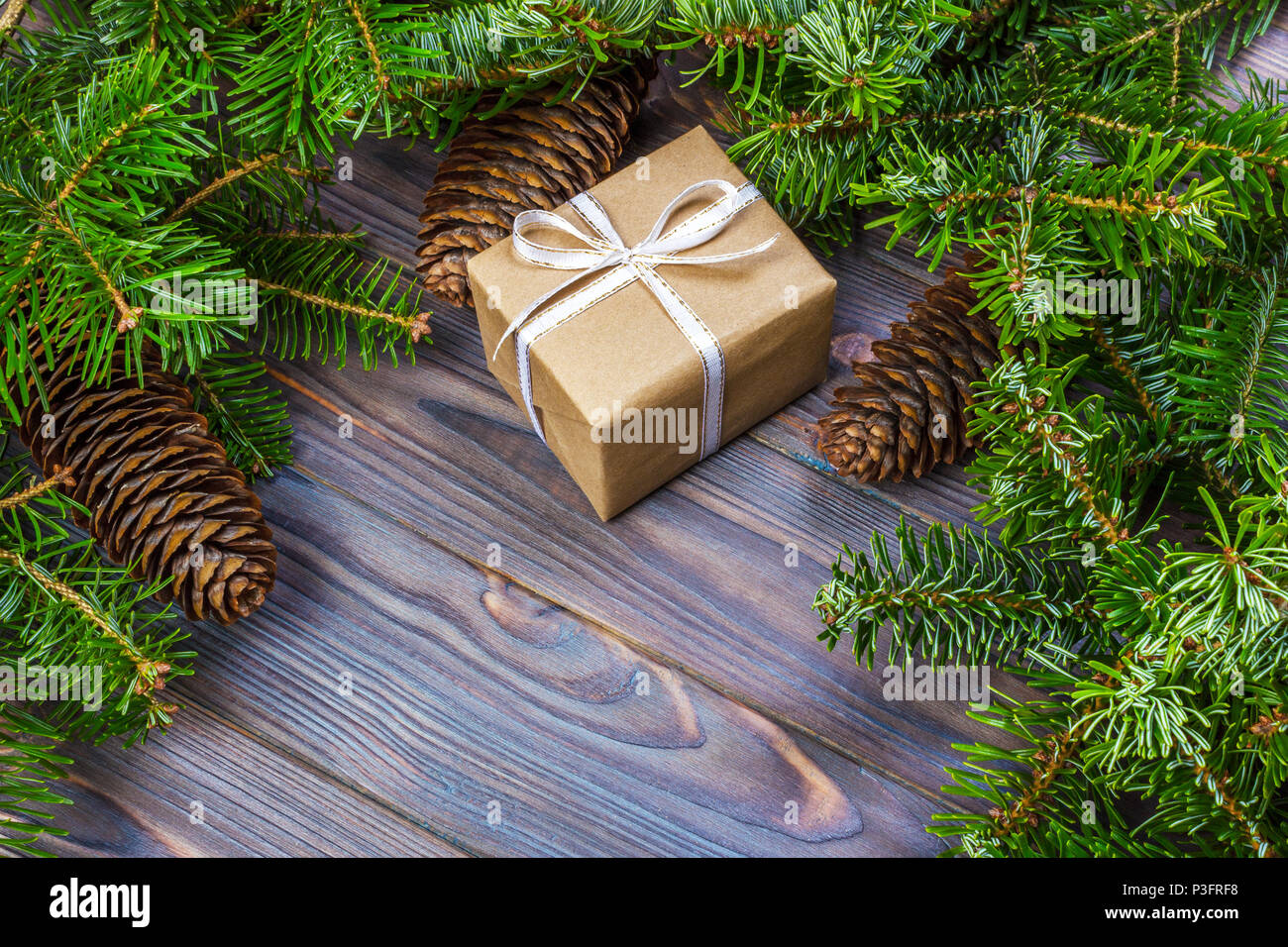 Christmas tree with gift box and decorations on wooden background space ...