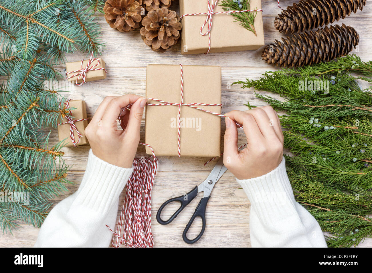 Process of packing boxes with Christmas gifts presents. Top view Stock ...