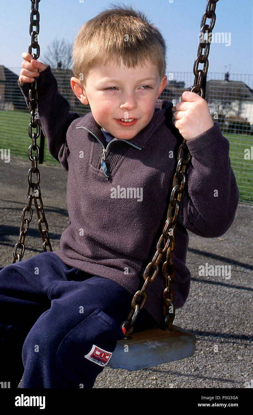 Toddler on a swing in the playground Stock Photo - Alamy