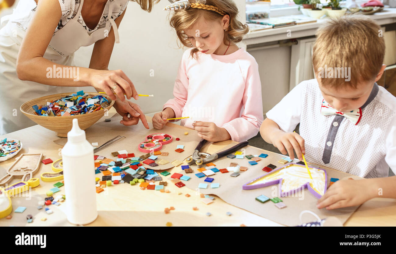 mosaic puzzle art for kids, children's creative game. two sisters are ...