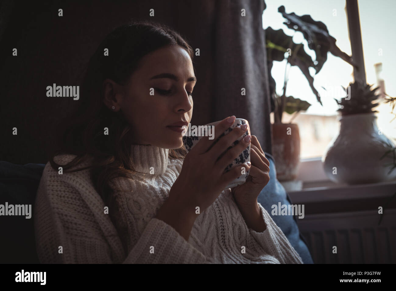 Beautiful woman smelling the aroma of the tea Stock Photo - Alamy