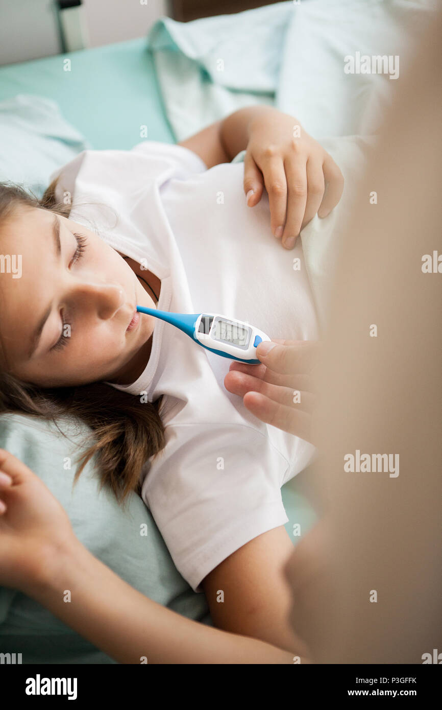 Doctor taking body temperature of her patient Stock Photo - Alamy