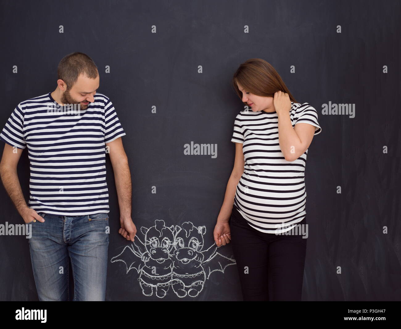 Conceptual photo of pregnant couple drawing their imaginations about ...