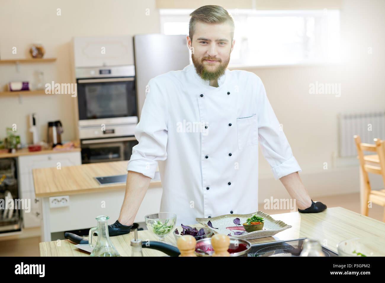 Handsome Chef Posing in Kitchen Stock Photo - Alamy