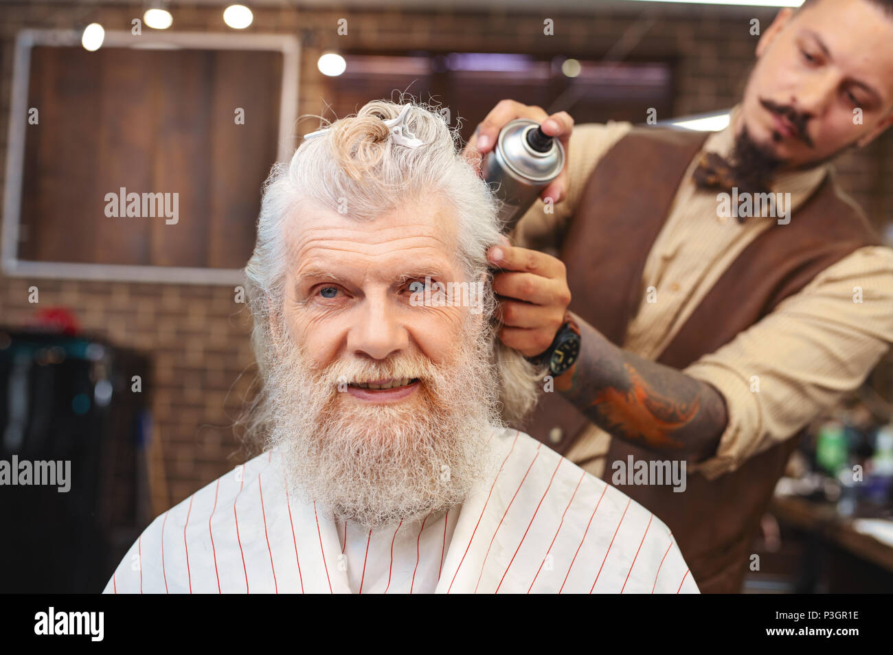 Professional barber modelling stylish hairstyle Stock Photo - Alamy