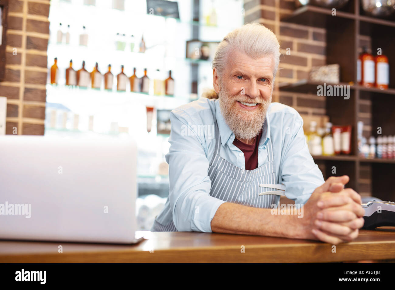 Happy mature man waiting for clients Stock Photo - Alamy