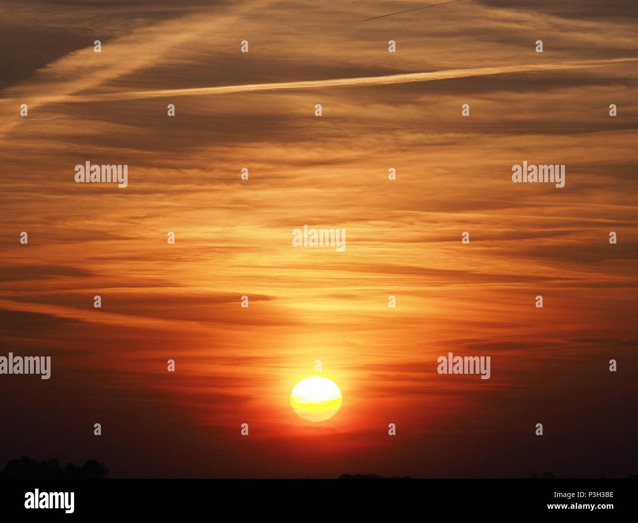 Impressive colored sky at sun set with clouds formation seen from ...