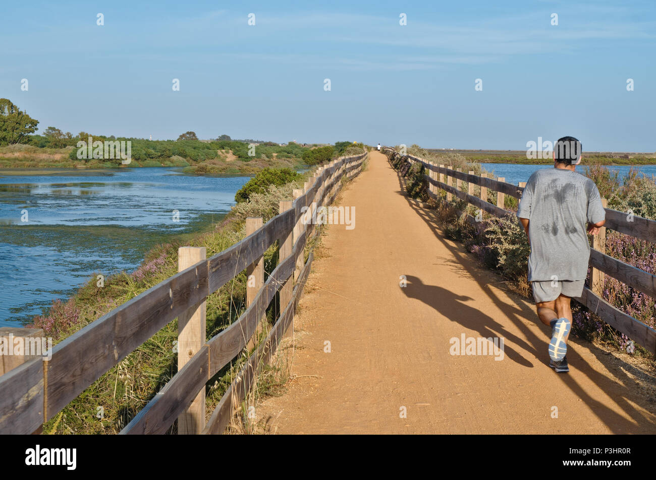 Runner in hiking path from Quinta do Lago to Faro. Algarve, Portugal ...