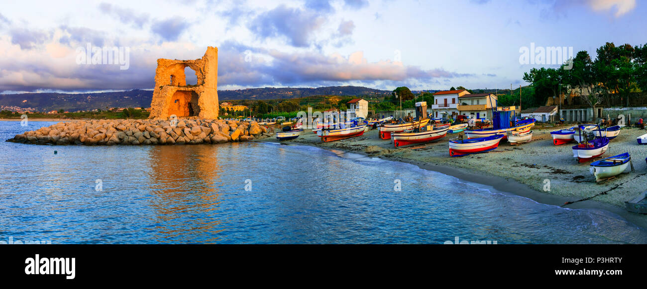 Old tower ,fishing boats over sunset in Briatico,Calabria,Italy Stock ...