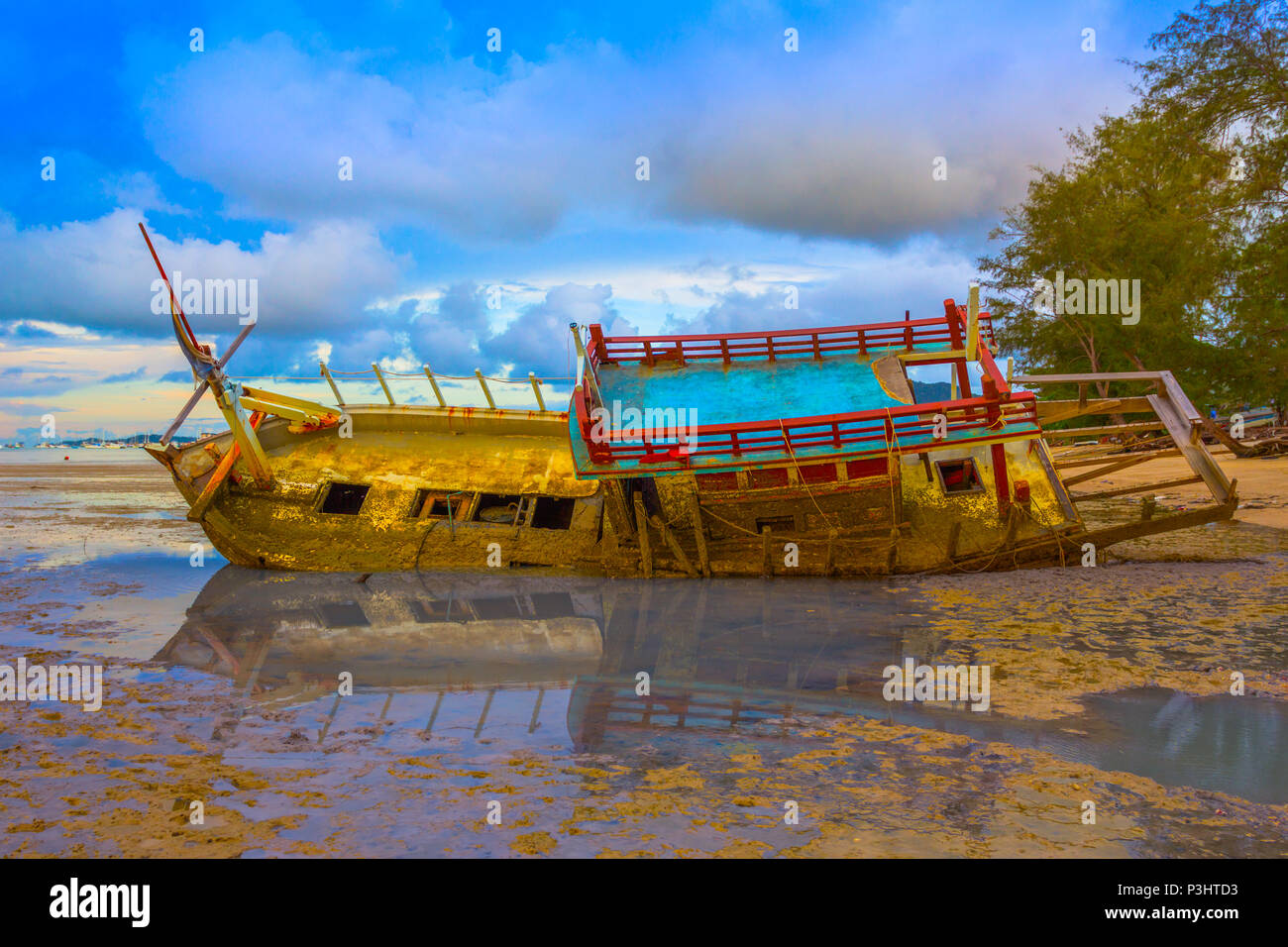 the old ship wreck stuck on the mud near Chalong gulf Stock Photo - Alamy
