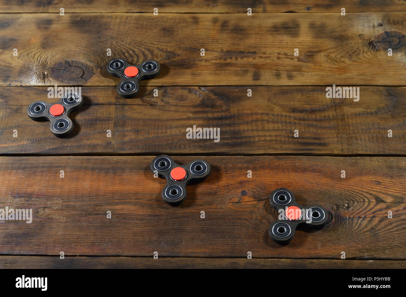 A rare handmade wooden fidget spinners lies on a brown wooden ...