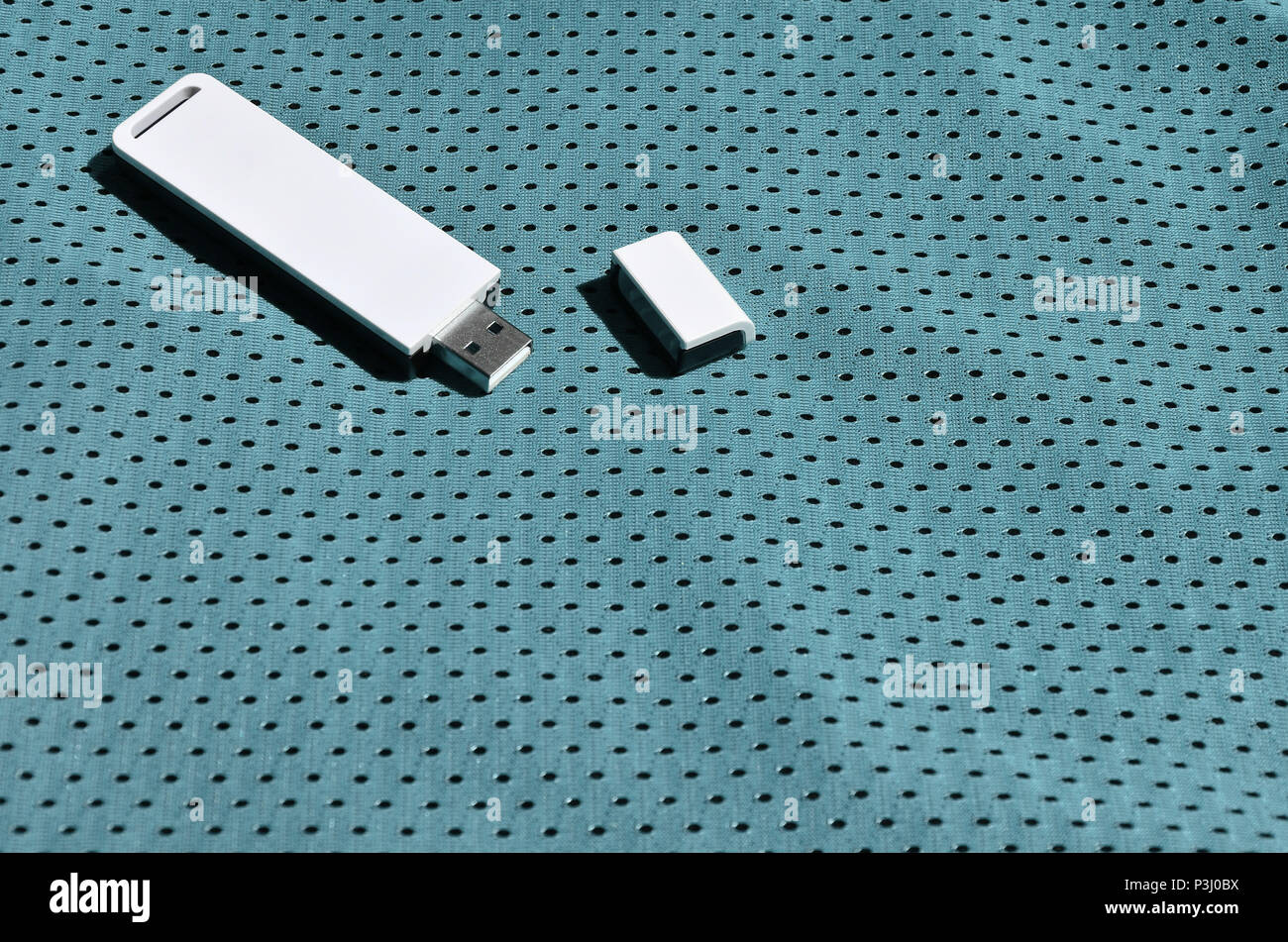 A modern portable USB wi-fi adapter is placed on the blue sportswear ... A modern portable USB wi-fi adapter is placed on the blue sportswear ...